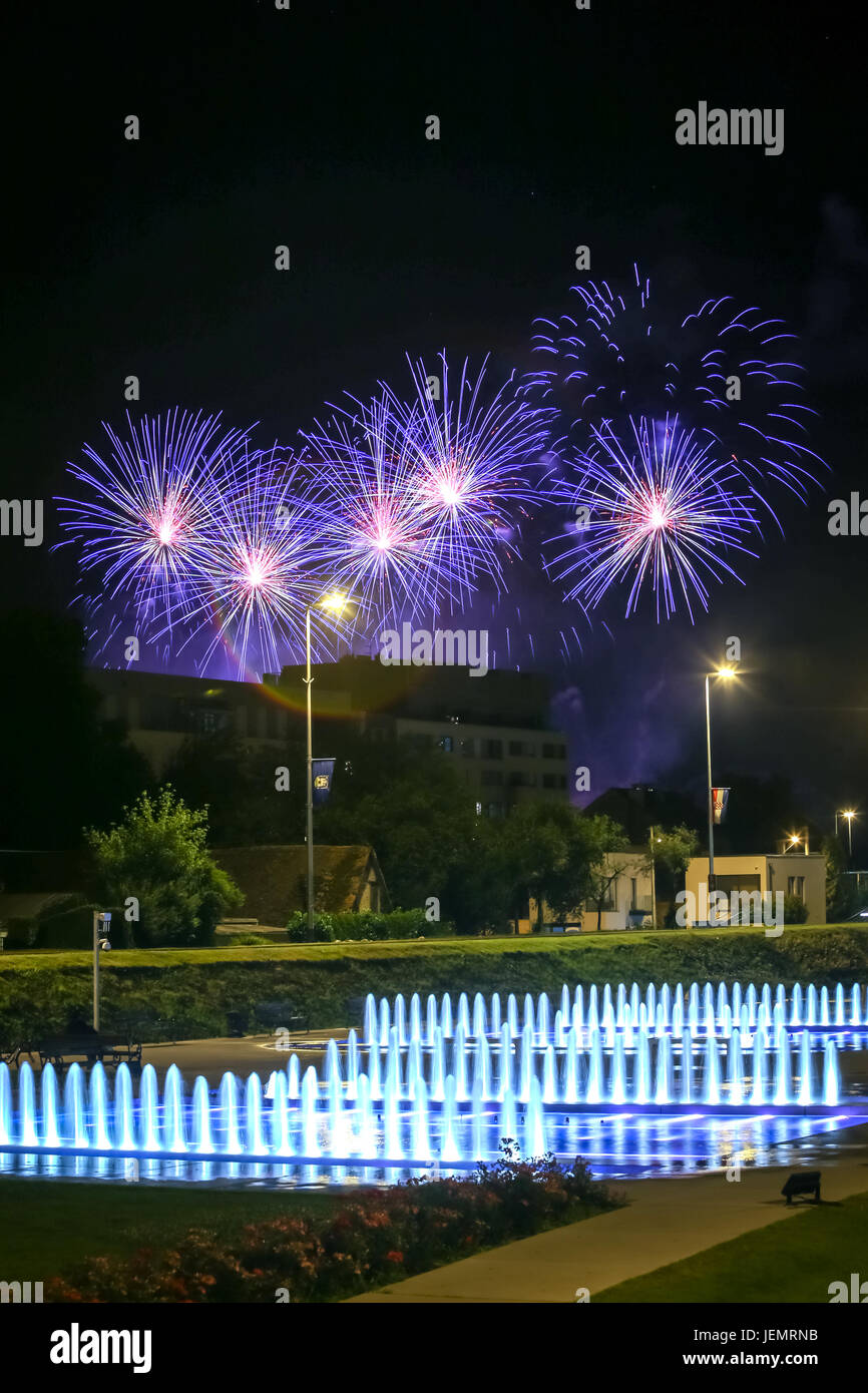 Brightly colorful fireworks above the city water fountains during the ...