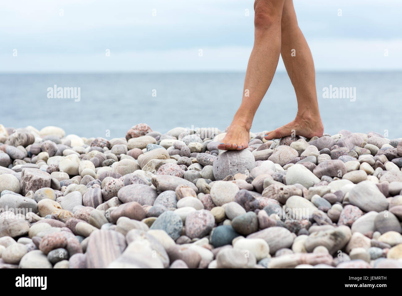 Person walking on pebbles Stock Photo - Alamy
