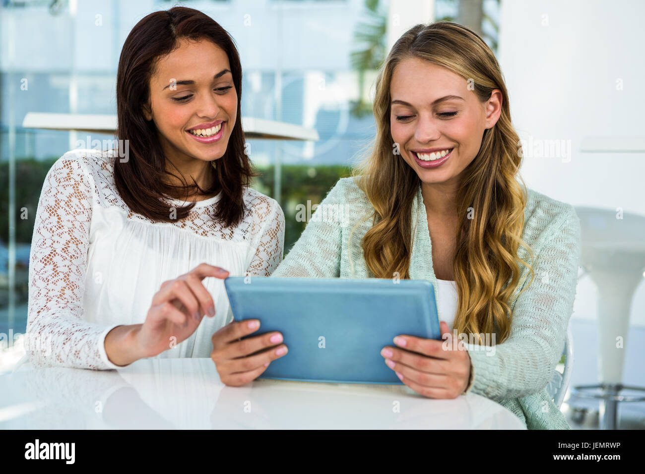 Two girls use a tablet Stock Photo - Alamy