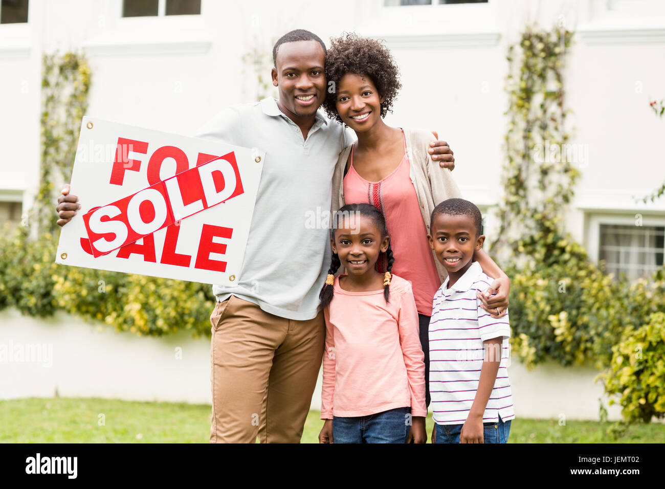 Happy family standing together Stock Photo - Alamy