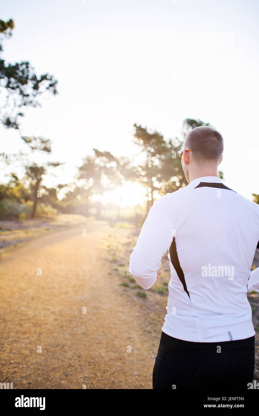 Man running on rural road rear view hi-res stock photography and images ...
