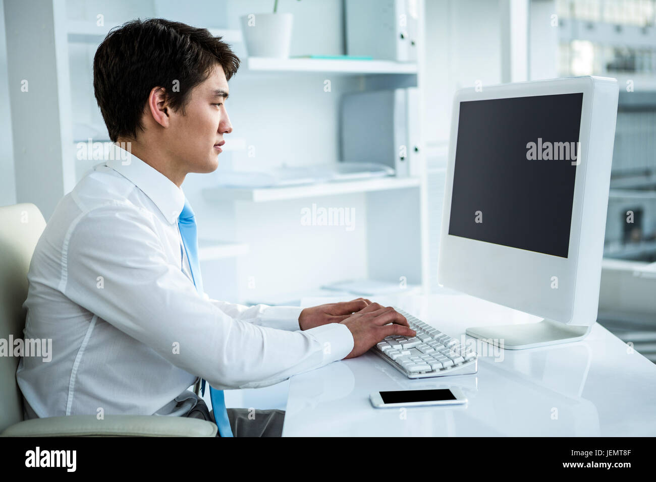 Asian businessman using his computer Stock Photo - Alamy