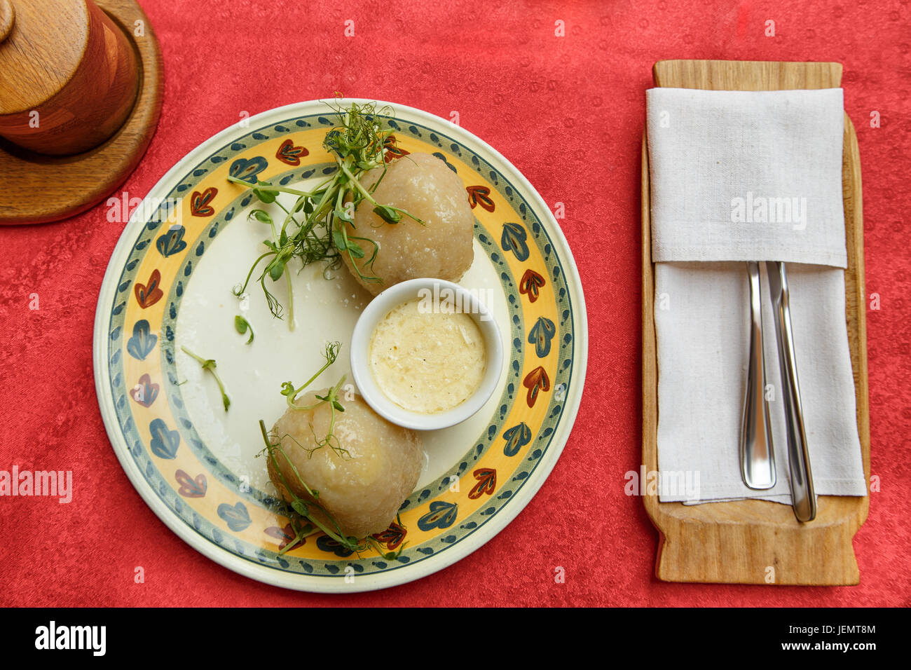 National Lithuanian dish - Zeppelin with sauce on a colored plate. Top ...