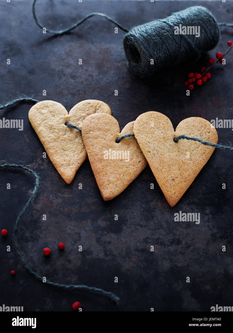 Heart shaped cookies on string Stock Photo - Alamy