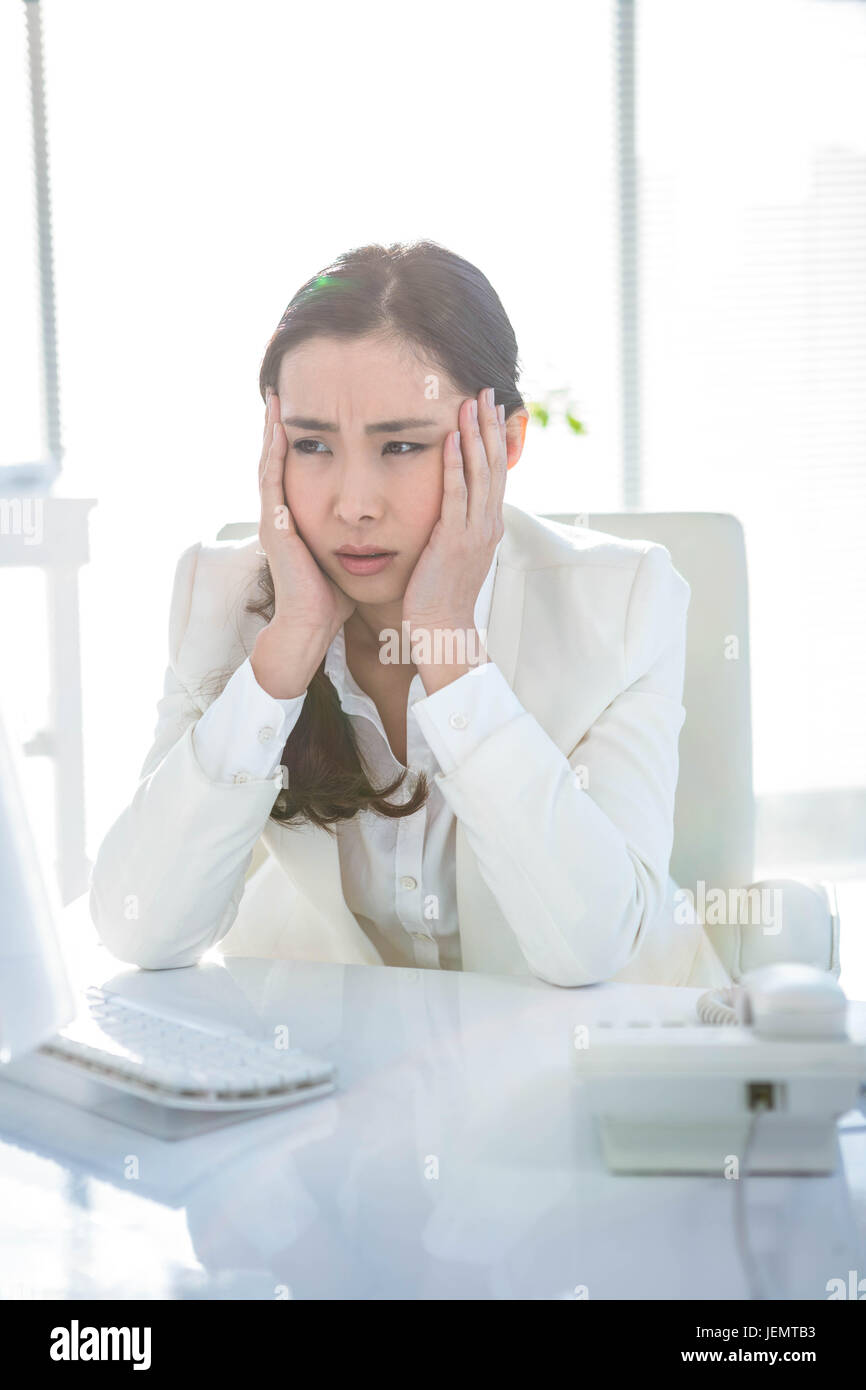 Stressed businesswoman working at her desk Stock Photo - Alamy