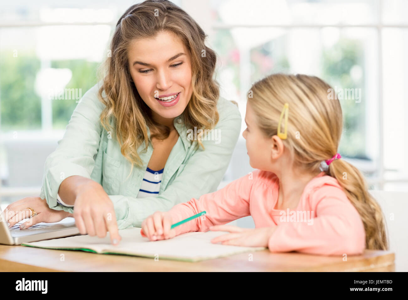 Mother checking daughters homework Stock Photo - Alamy