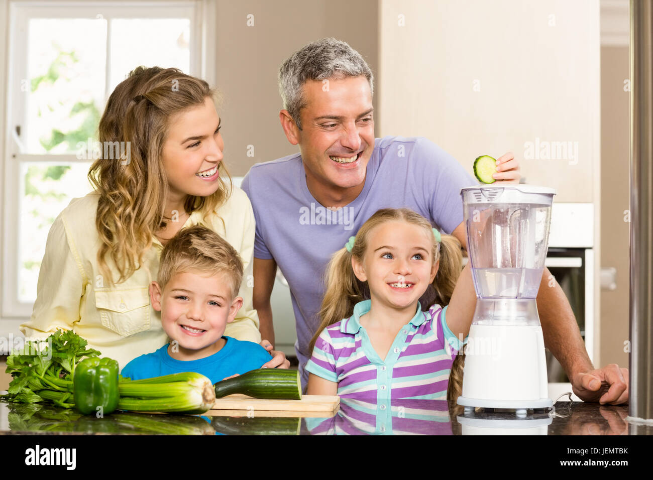 Happy family preparing healthy smoothie Stock Photo - Alamy