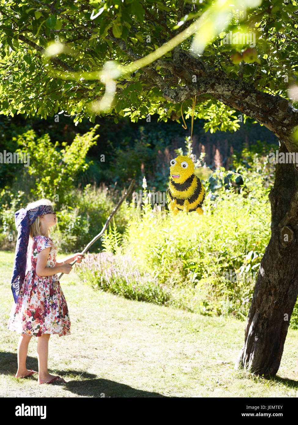Girl playing pinata Stock Photo - Alamy