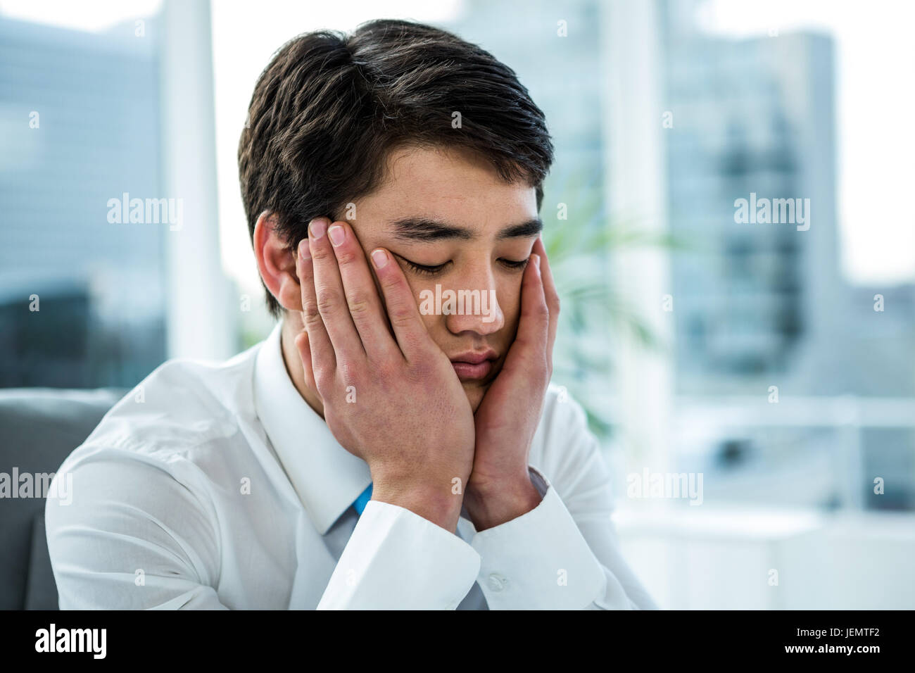 Thoughtful businessman with head in hands Stock Photo - Alamy