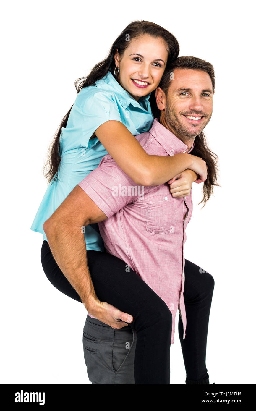 Smiling man carrying his girlfriend on back Stock Photo - Alamy