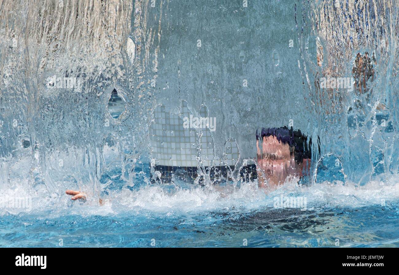 Woman at spa under waterfall shower Stock Photo - Alamy