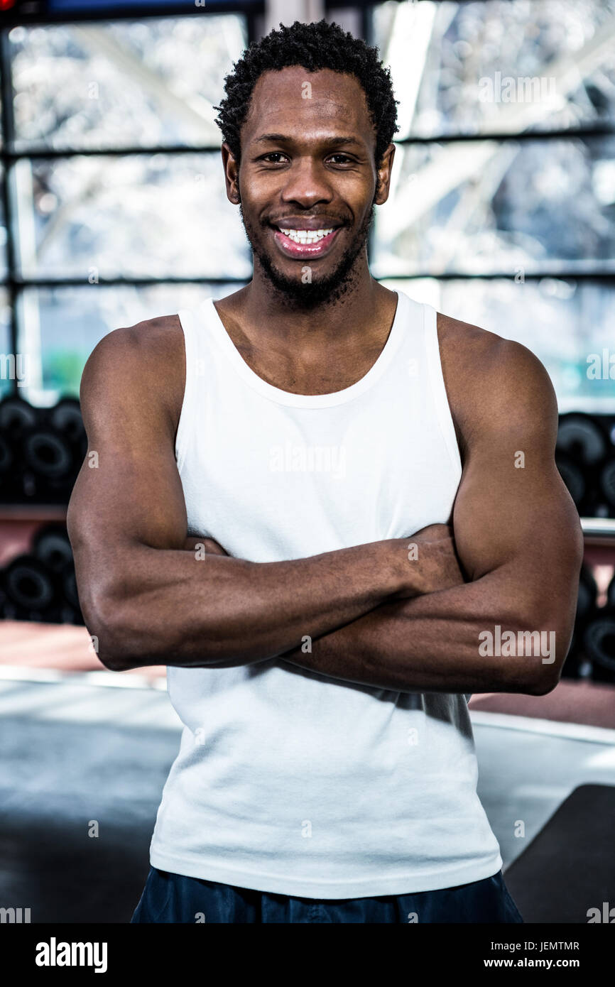 Muscular man posing with crossed arms Stock Photo - Alamy