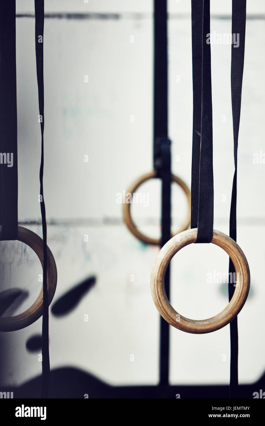Gymnastic rings in gym Stock Photo - Alamy