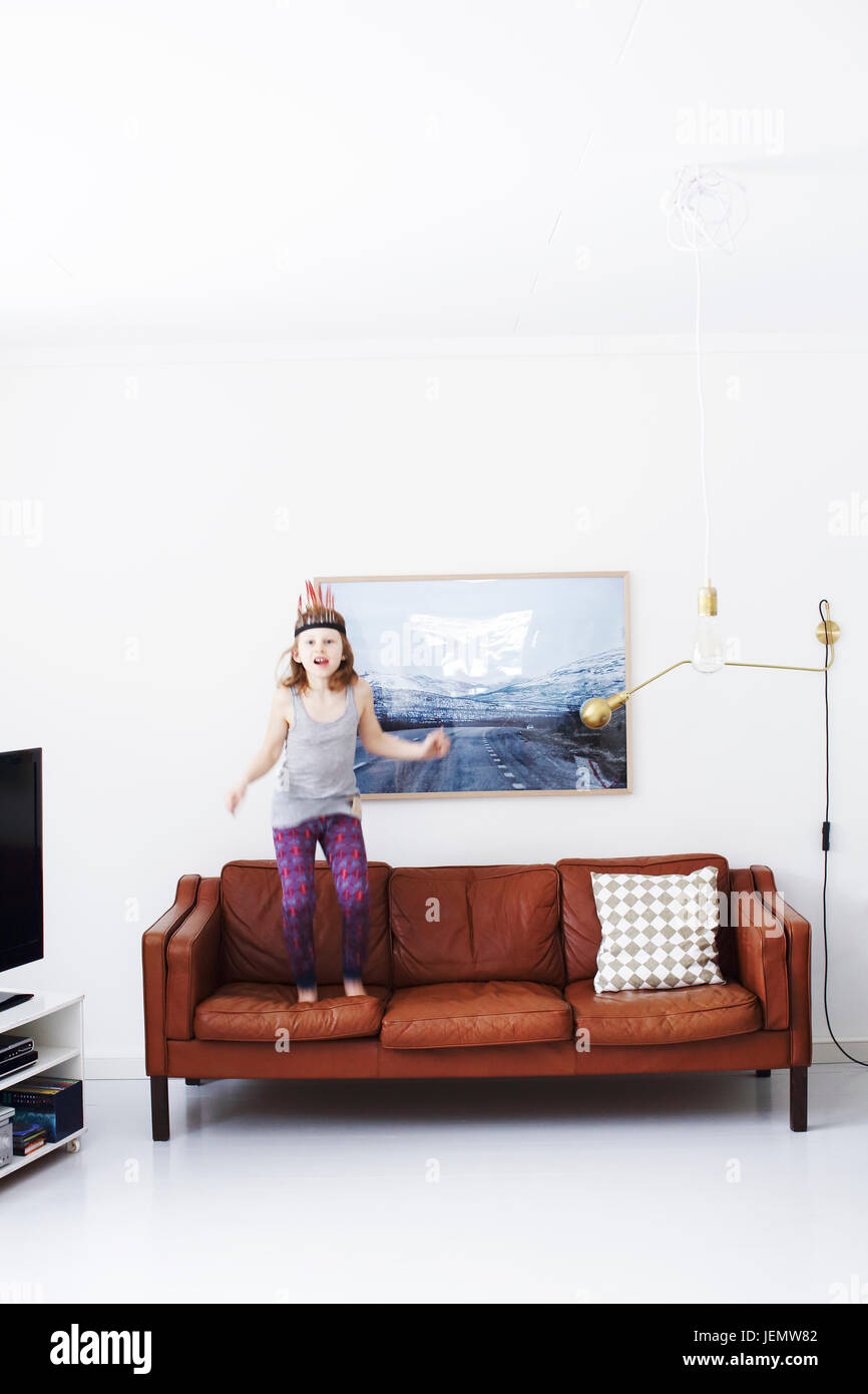 Happy girls dancing on sofa hi-res stock photography and images - Alamy