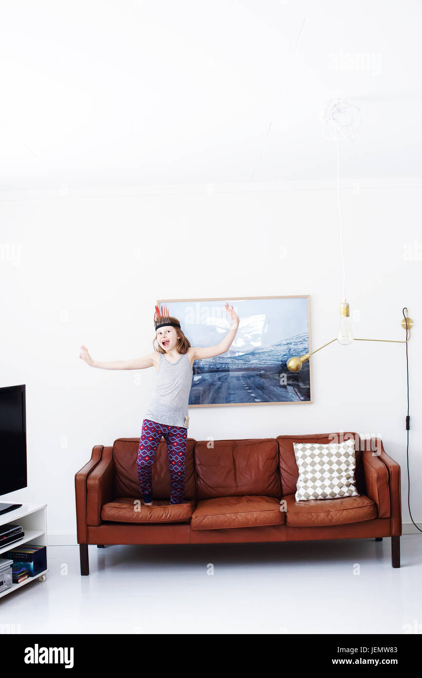 Happy girls dancing on sofa hi-res stock photography and images - Alamy