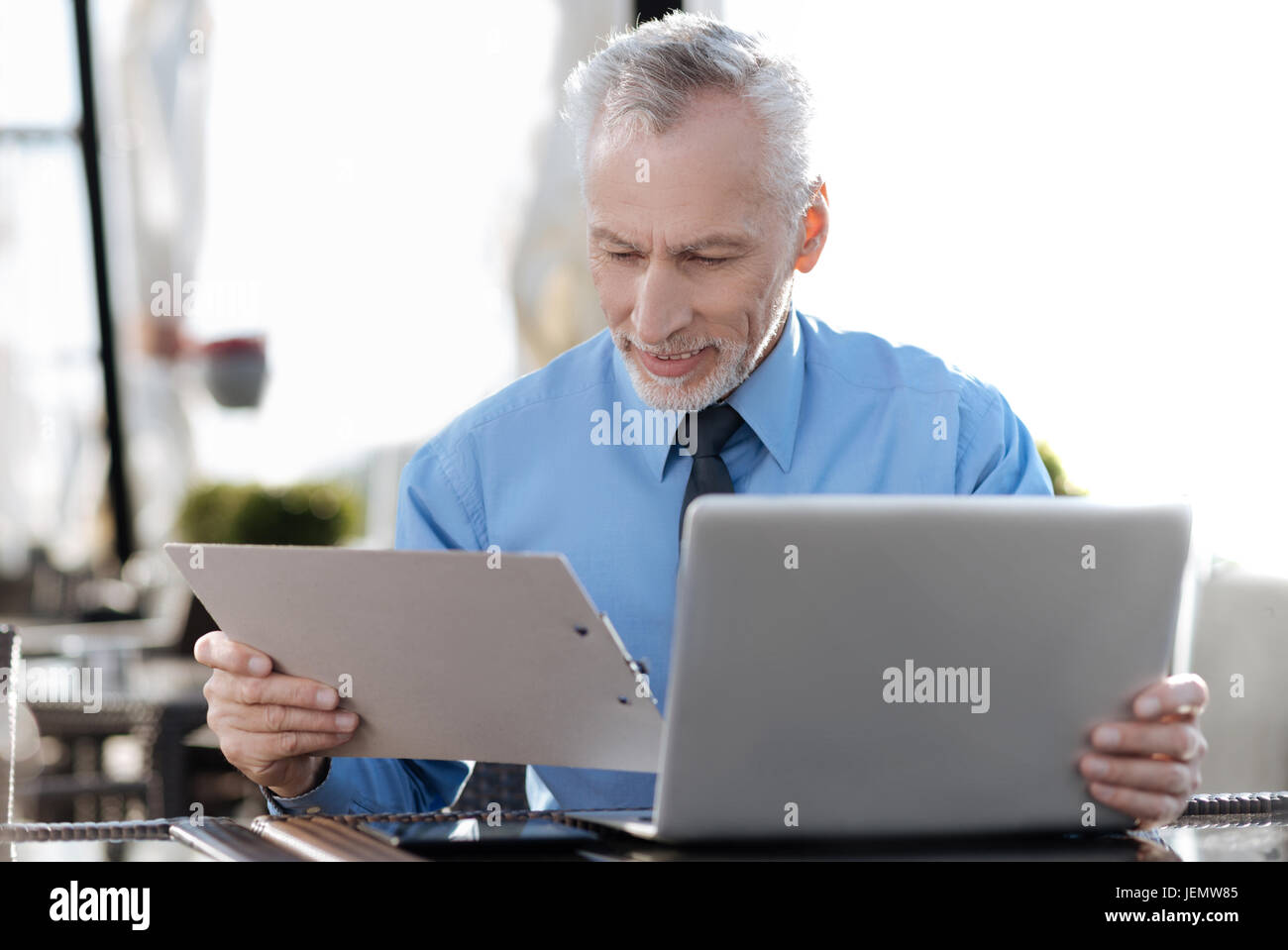 Positive delighted male person turning his head to folder Stock Photo ...