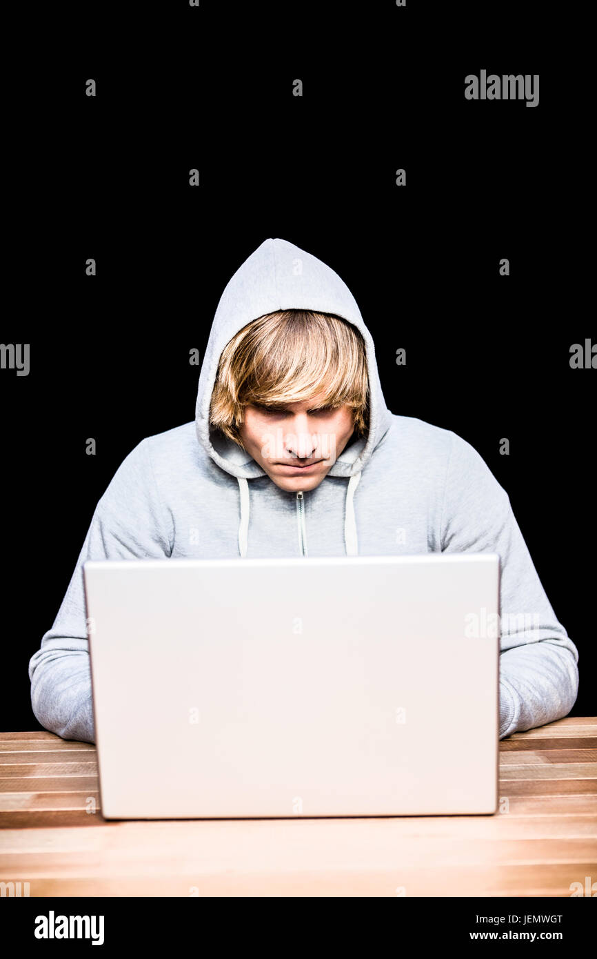 Young man using a laptop in secret hi-res stock photography and images ...