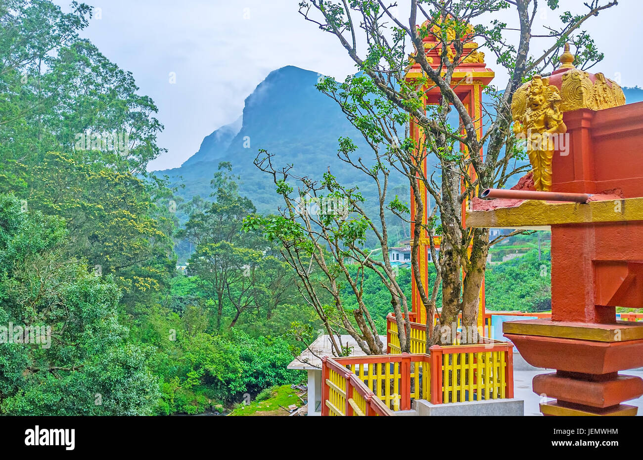 The tower of Seetha Amman Temple behind the tree, surrounded by foggy ...