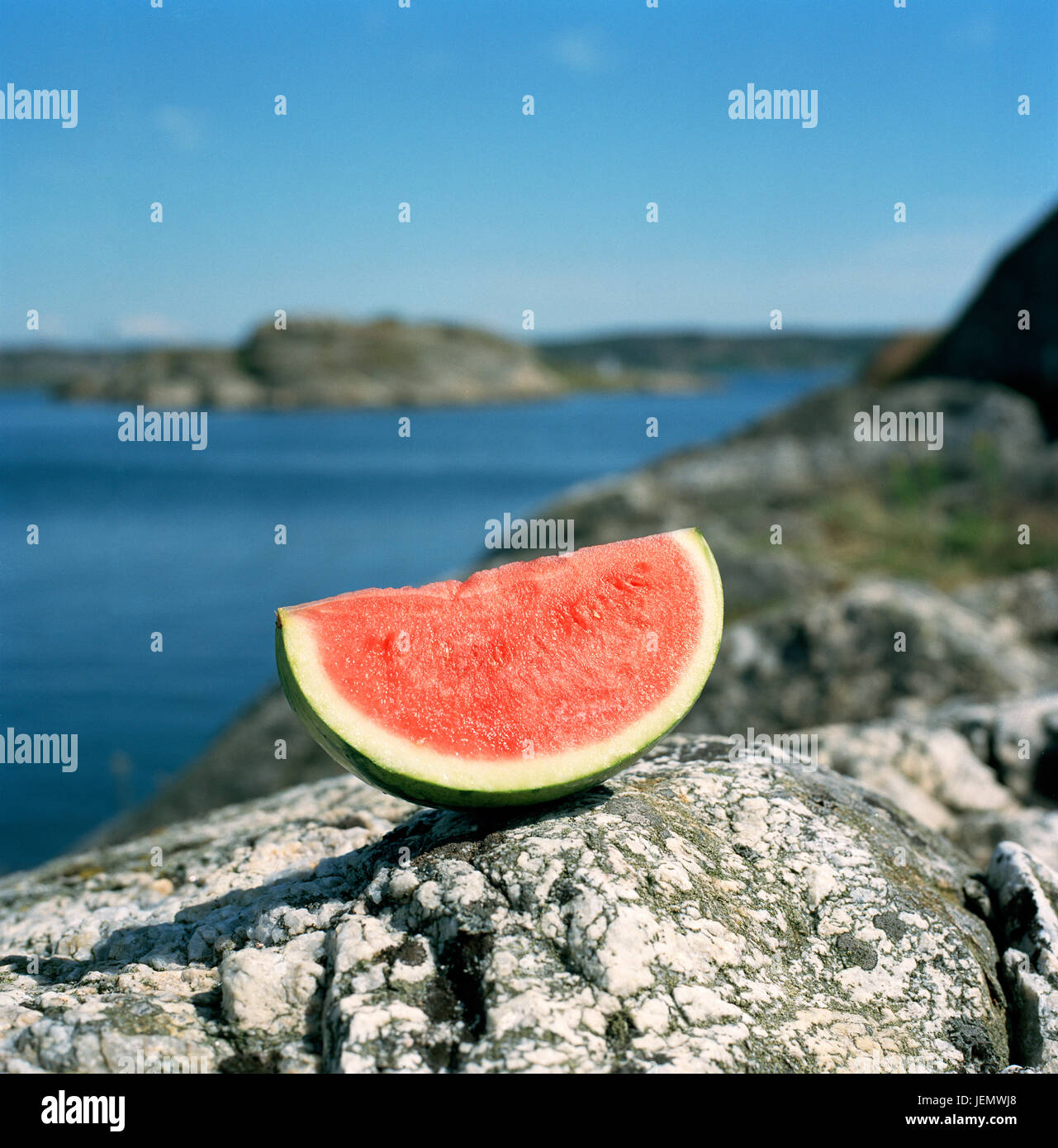Watermelon on rock Stock Photo - Alamy