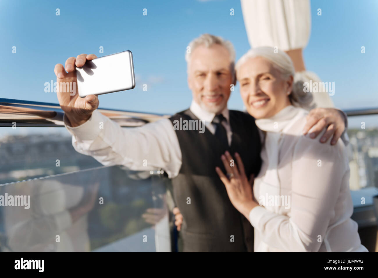 Happy people smiling while taking photo Stock Photo - Alamy