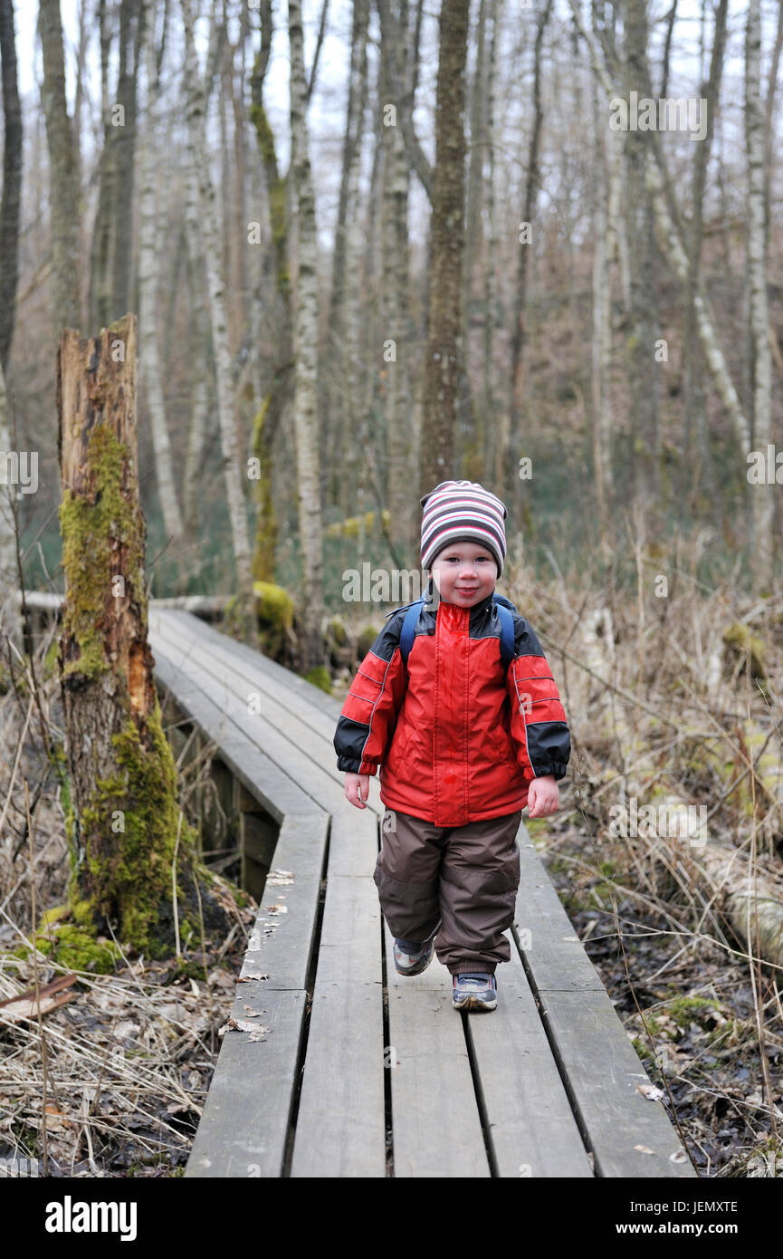 Boy walking in forest Stock Photo - Alamy