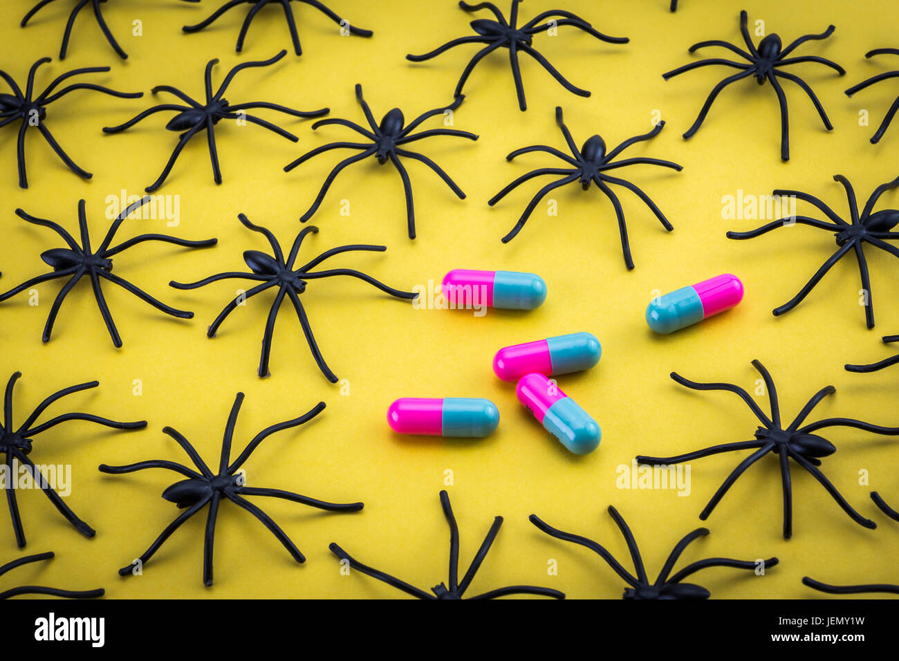 Spiders around capsules on yellow background, concept phobia to ...