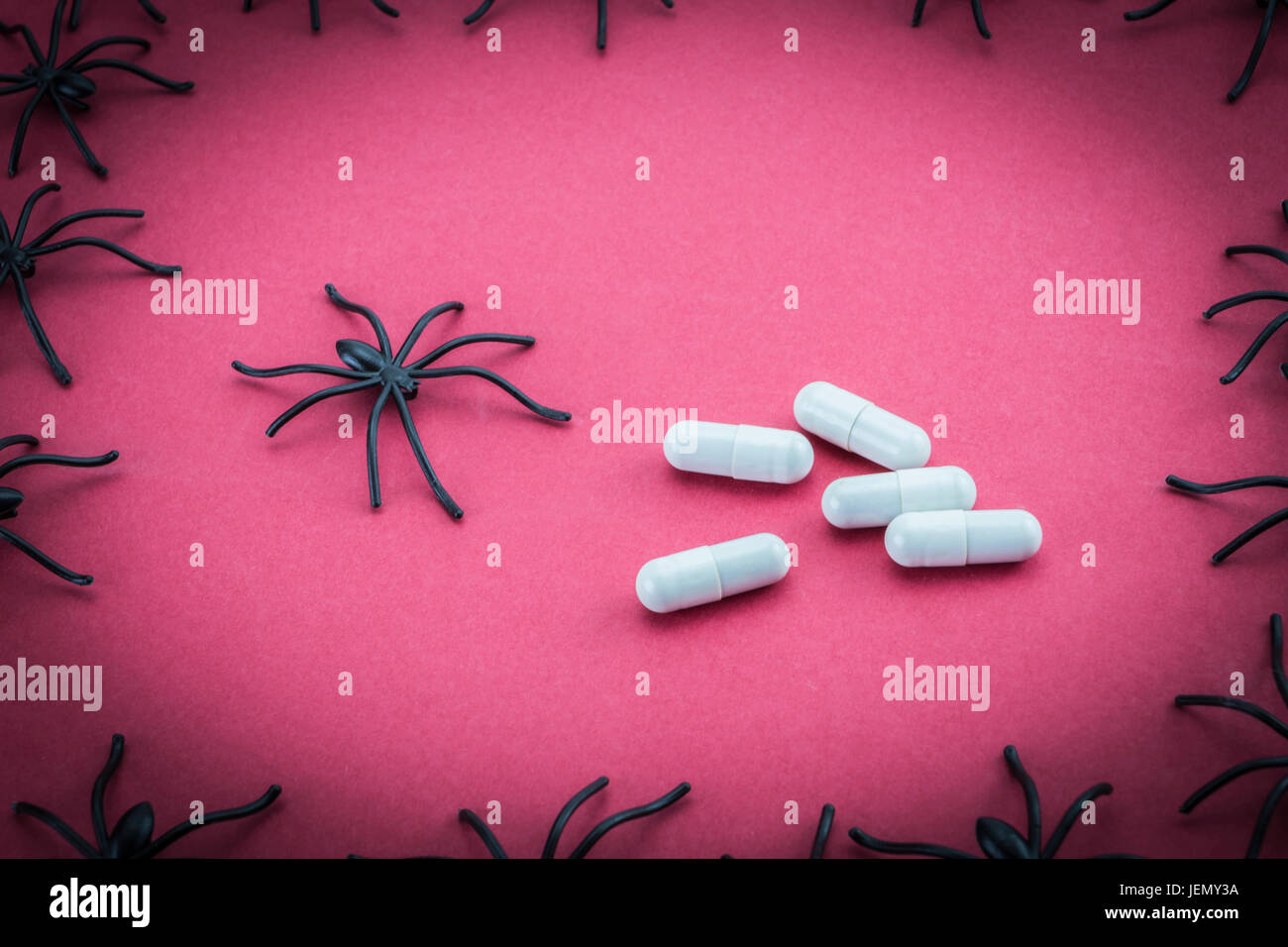 Spiders around capsules, concept phobia to medicines Stock Photo - Alamy