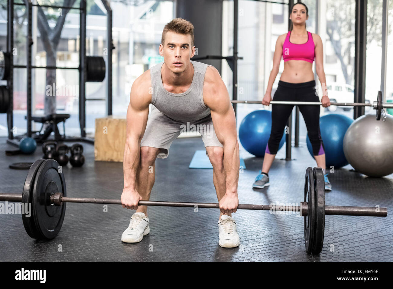 Fit couple lifting barbell Stock Photo - Alamy