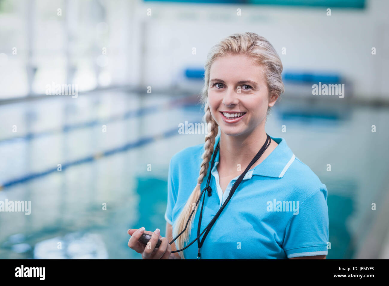 Pretty trainer holding a stopwatch Stock Photo - Alamy