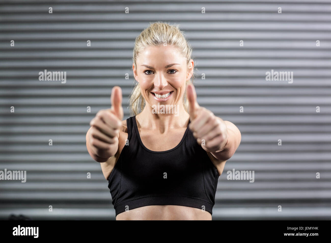 Attractive female showing muscles hi-res stock photography and images ...