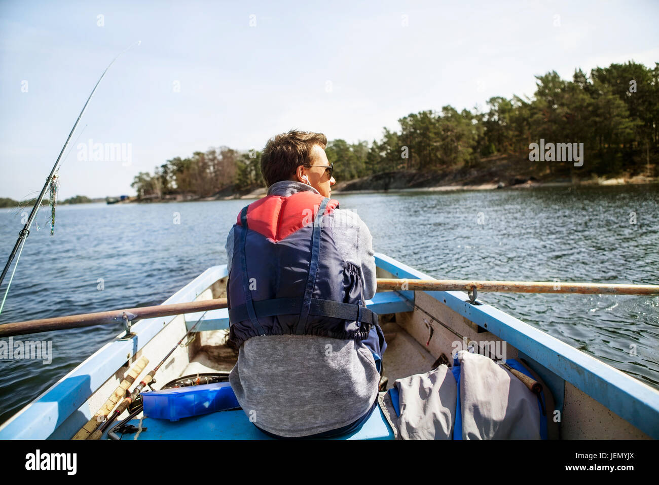 Young man sitting on motorboat hi-res stock photography and images - Alamy