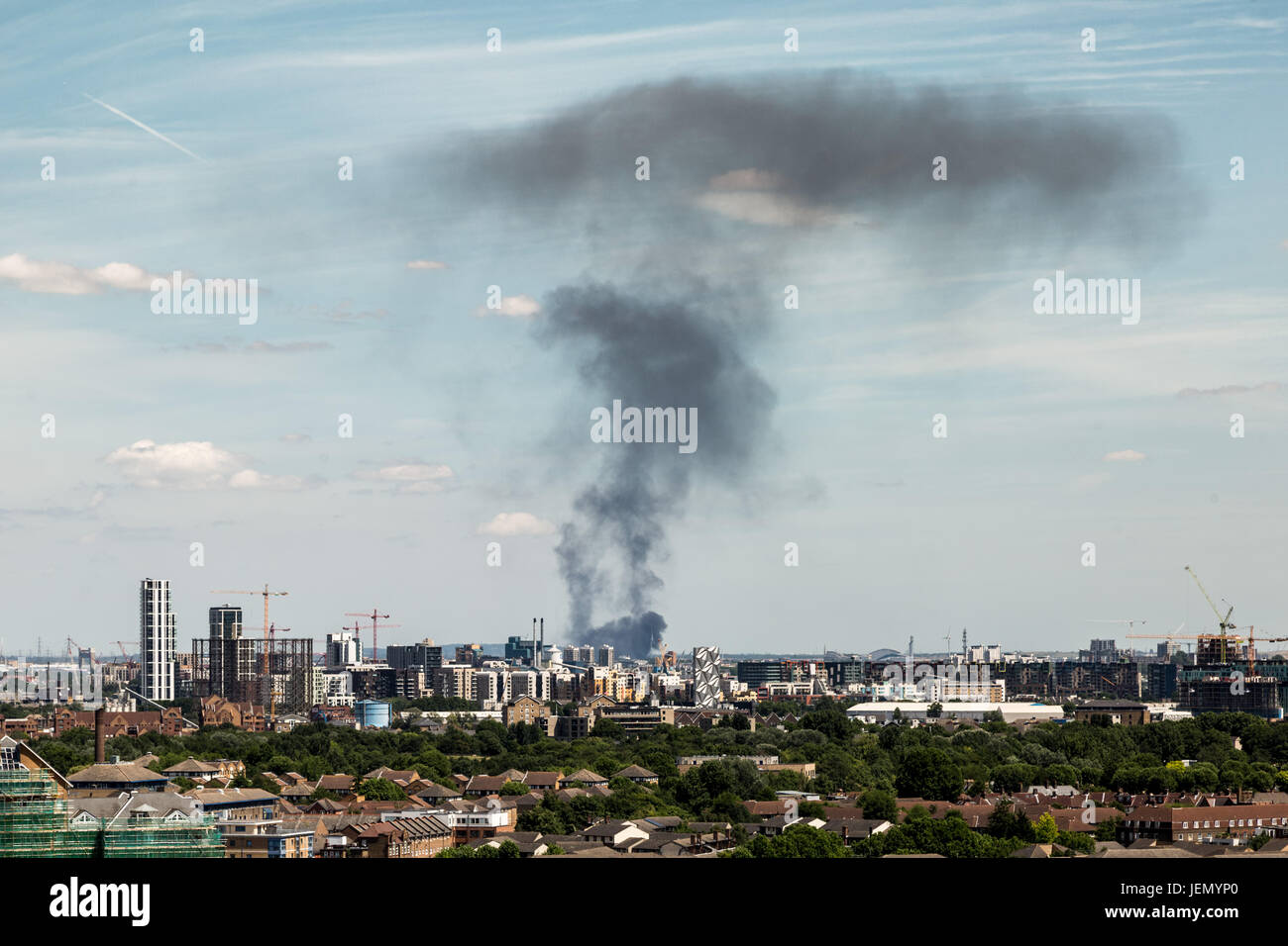 London, UK. 26th June, 2017. Black smoke rises from a large fire in a ...