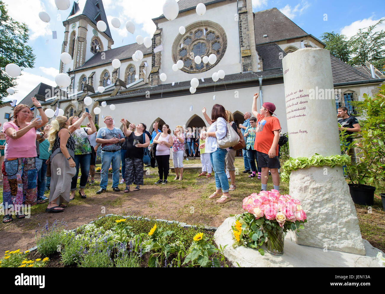 Balloons are released after the unveiling of a new memorial in honour ...