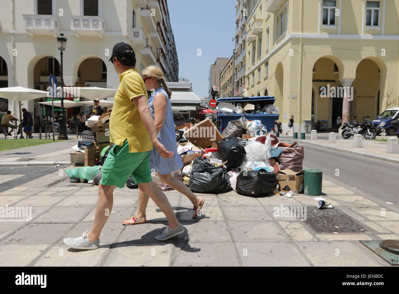 Thessaloniki, Greece. June 27th, 2017. People walk pass piles of litter ...