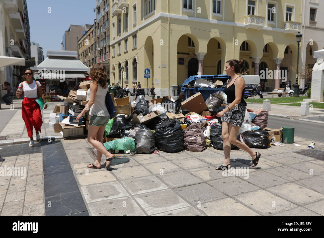Thessaloniki, Greece. June 27th, 2017. People walk pass piles of litter ...