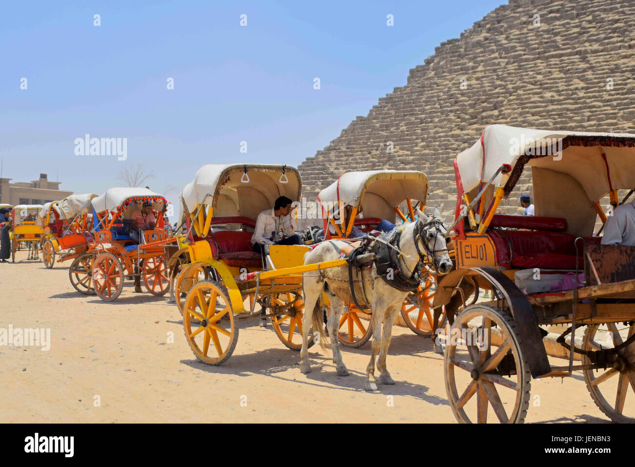 Cairo, Egypt. 27th June, 2017. Egyptians ride horse carts in front of the Giza pyramids, on the ...