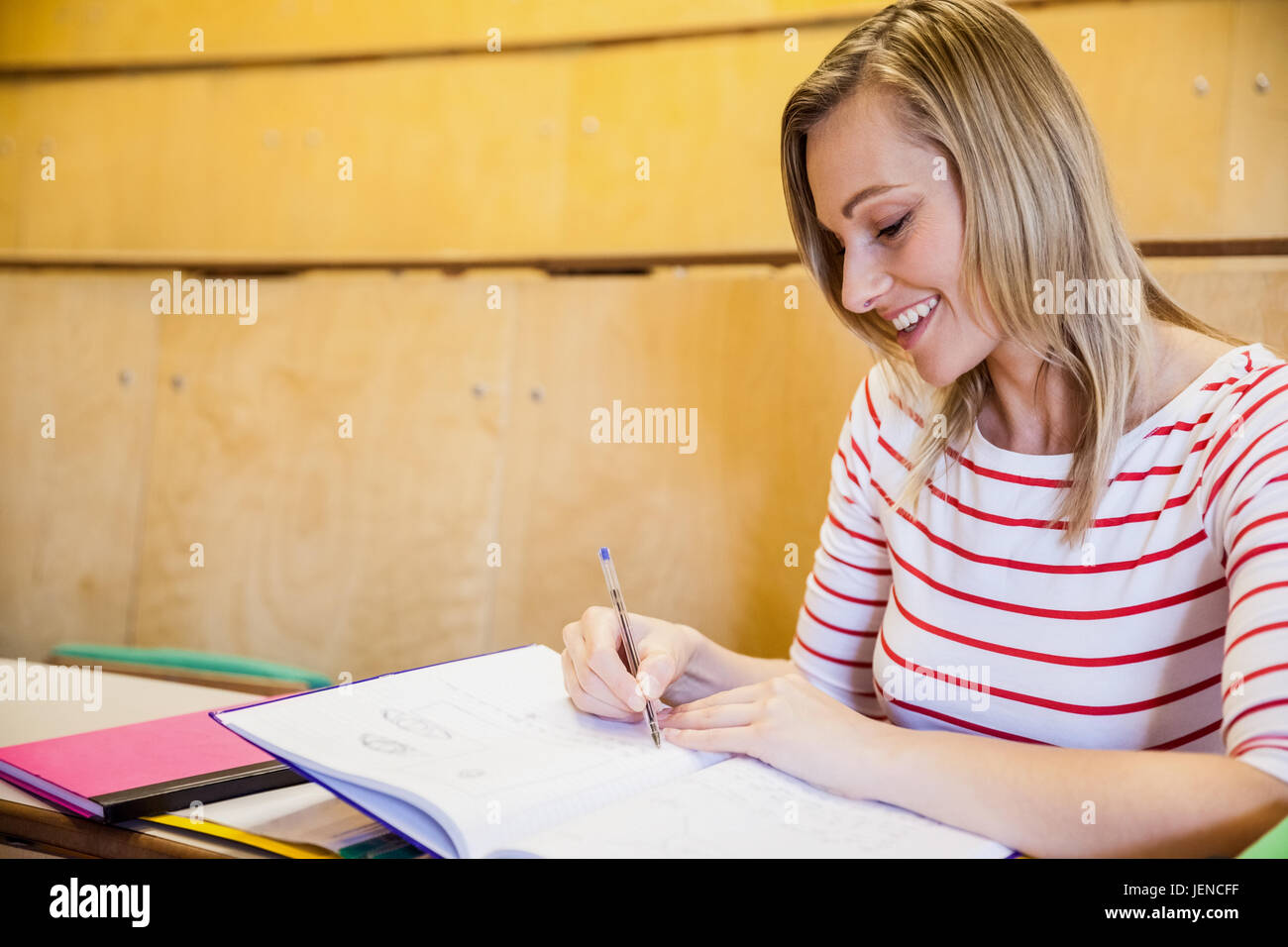 happy female student writing notes Stock Photo - Alamy