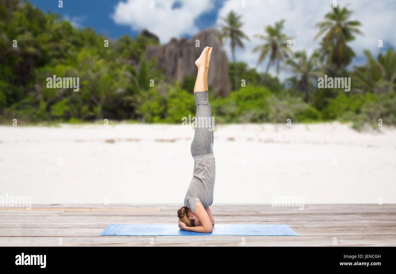 Woman doing headstand on beach hi-res stock photography and images - Alamy
