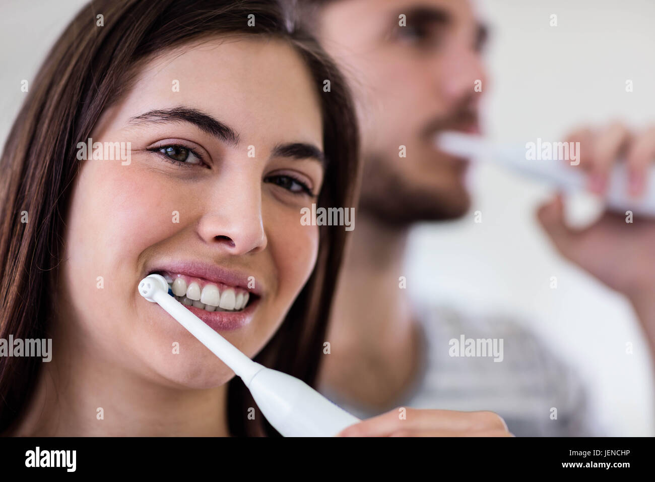 Couple brushing their teeth Stock Photo - Alamy