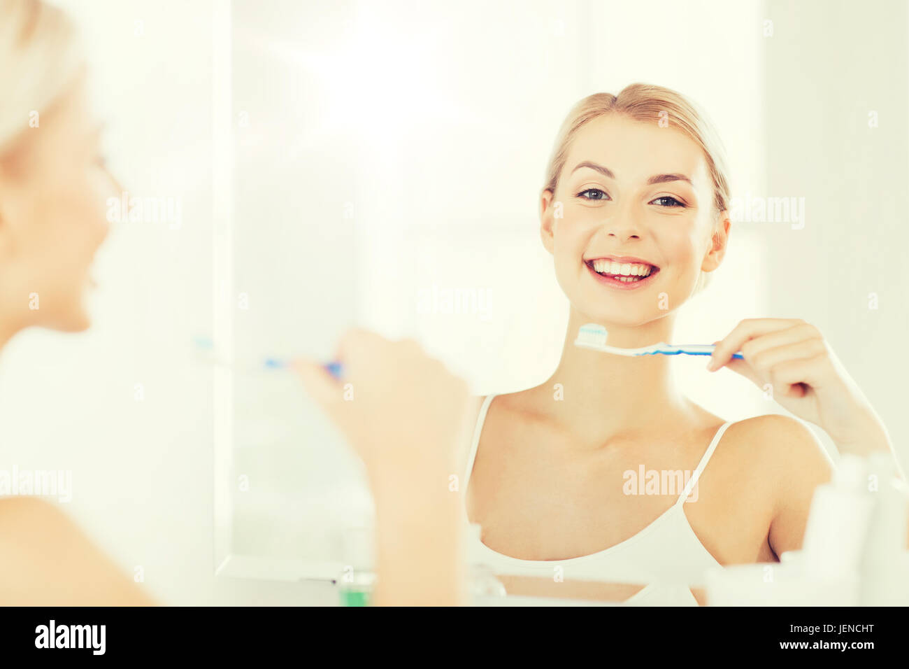 woman with toothbrush cleaning teeth at bathroom Stock Photo - Alamy