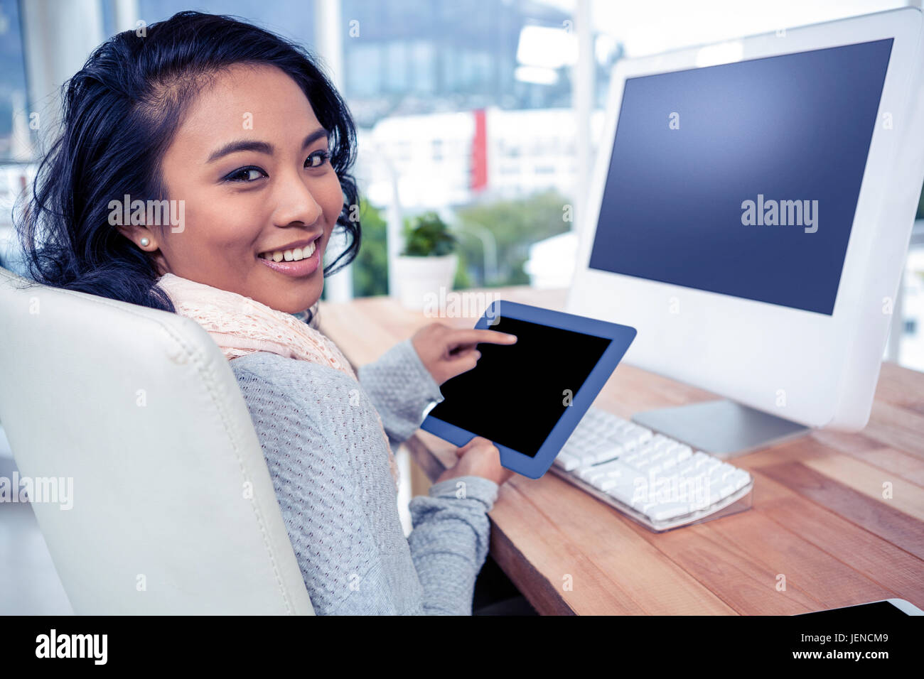 Smiling Asian woman using tablet Stock Photo - Alamy