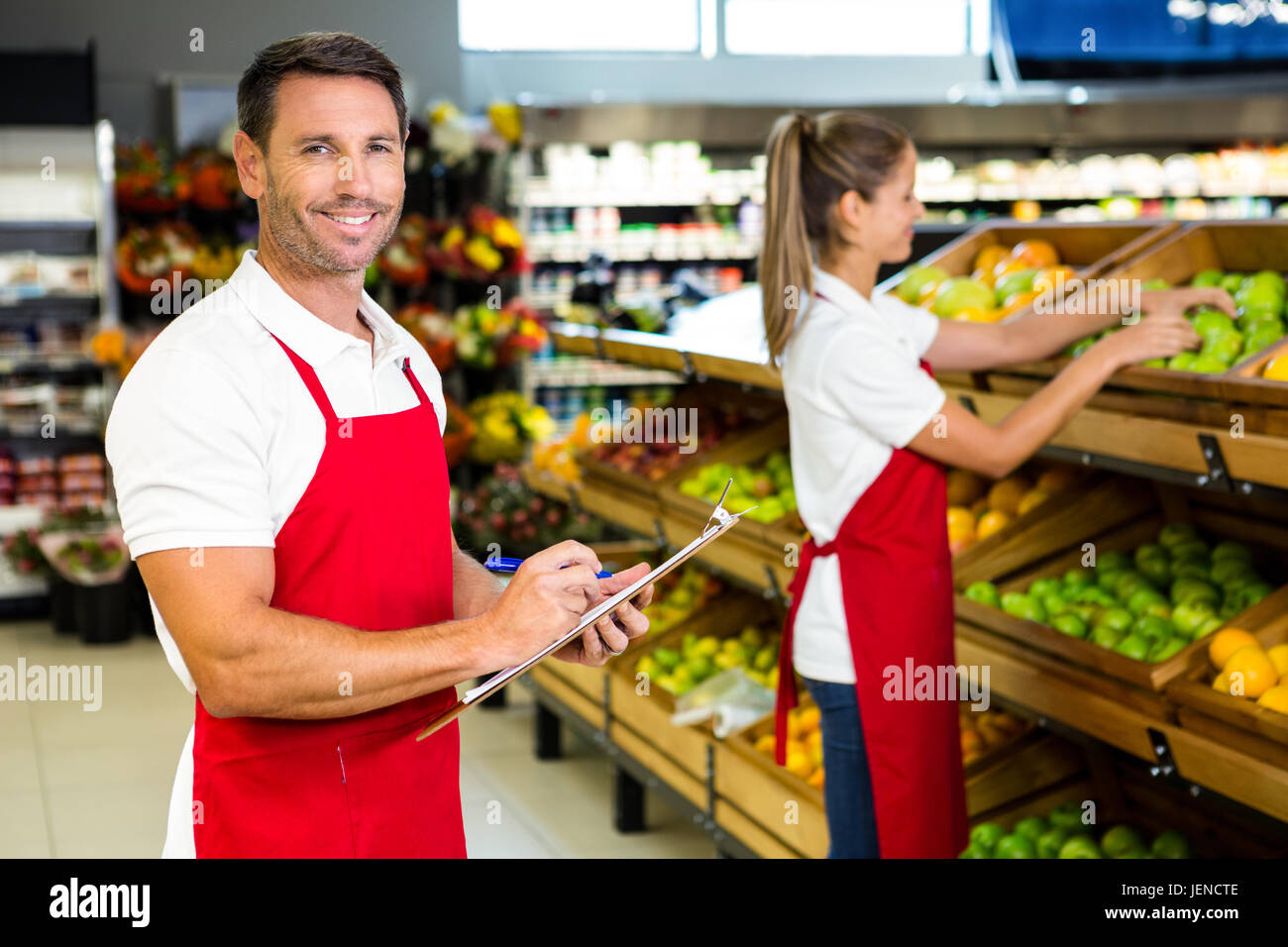 Grocery store staff with clipboard Stock Photo - Alamy
