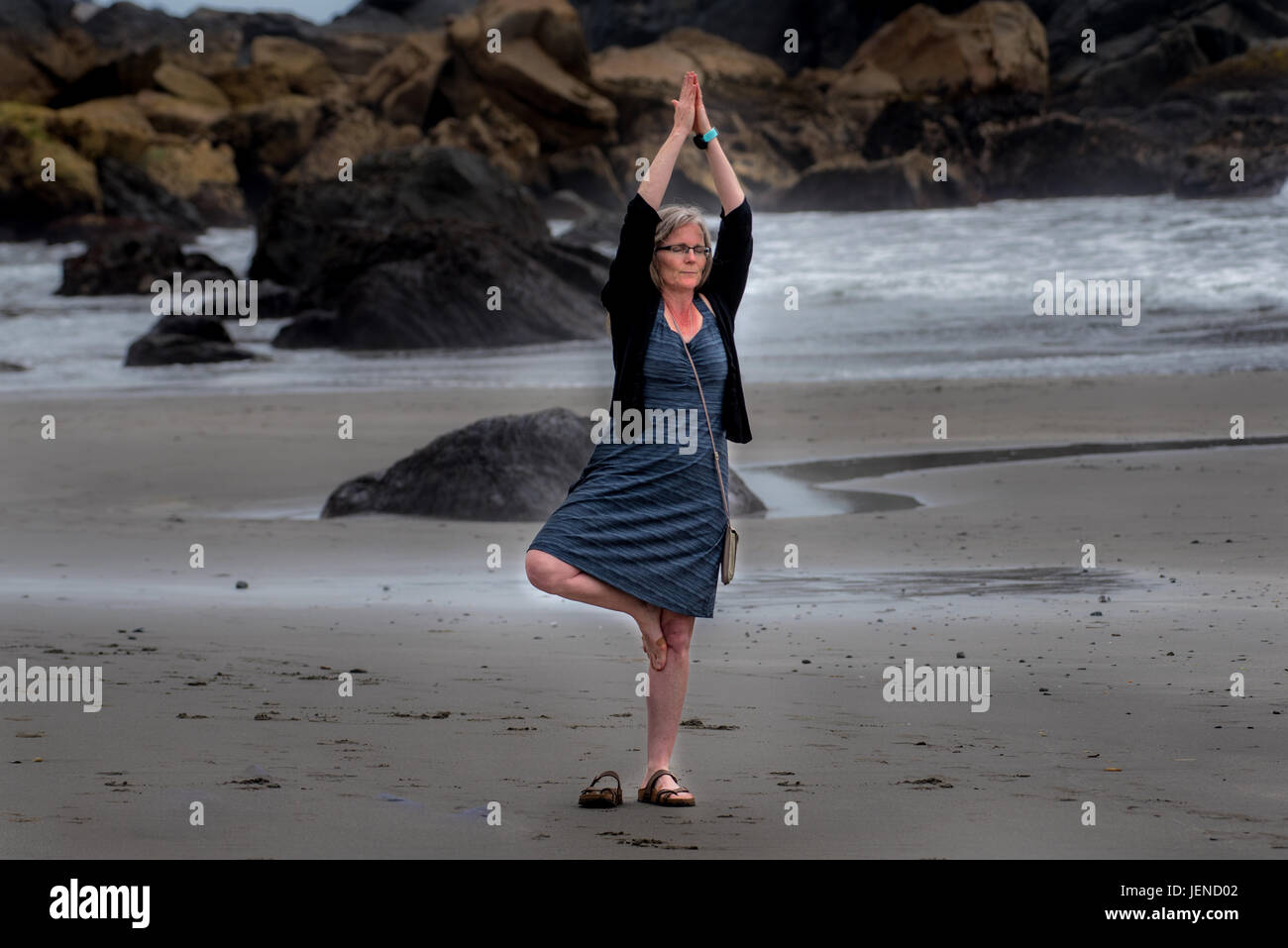 Woman doing yoga (tree pose) on the beach, Oregon, United States Stock ...