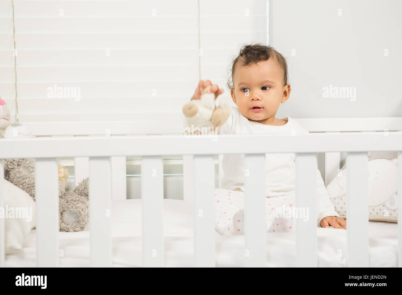 Cute baby playing with plush Stock Photo - Alamy