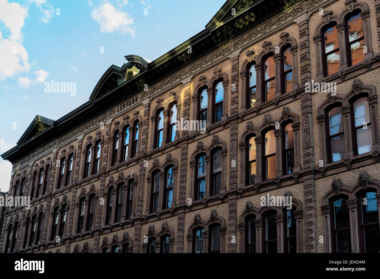 Old building with windows reflecting light Stock Photo - Alamy