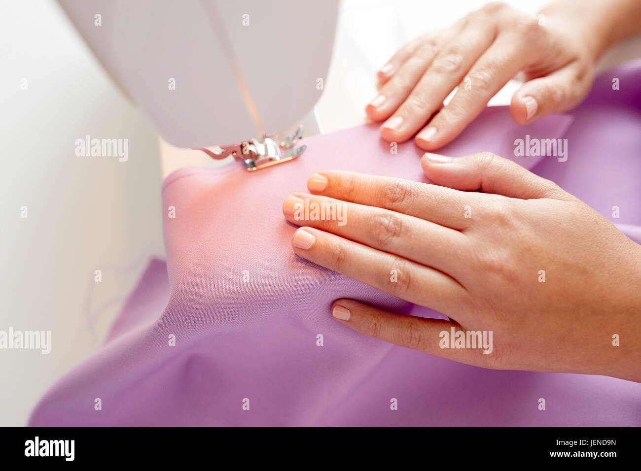 tailor woman with sewing machine stitching fabric Stock Photo - Alamy