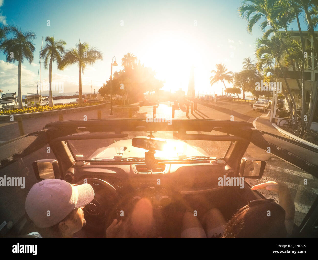 Rear view of a couple driving in a convertible, Lahaina, Maui, Hawaii ...