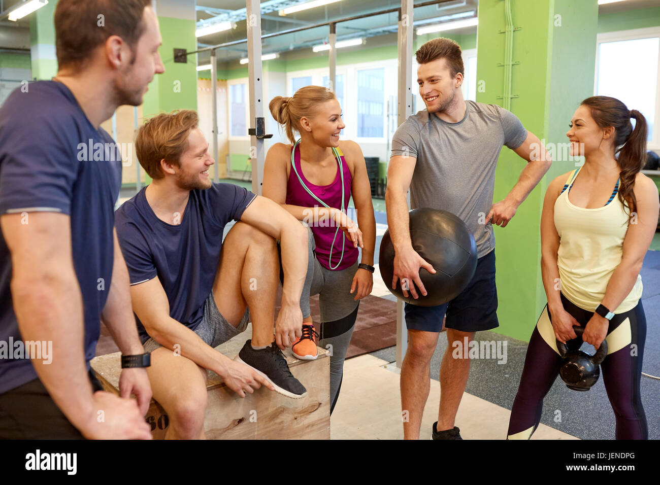 group of friends with sports equipment in gym Stock Photo - Alamy