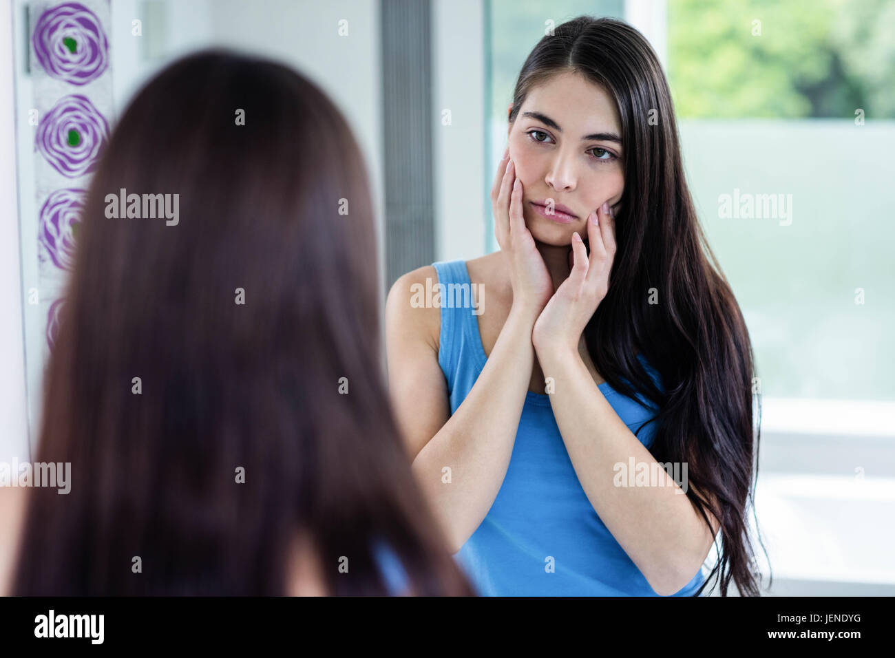 Sad brunette in bathroom Stock Photo - Alamy