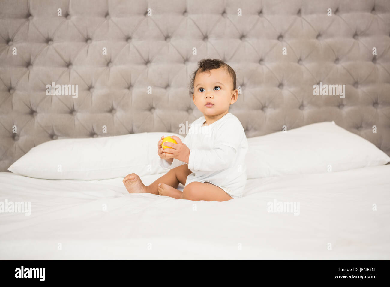 Cute baby playing with ball Stock Photo - Alamy